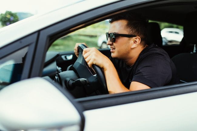 scared funny looking young man driver in the car. Human emotion face ...