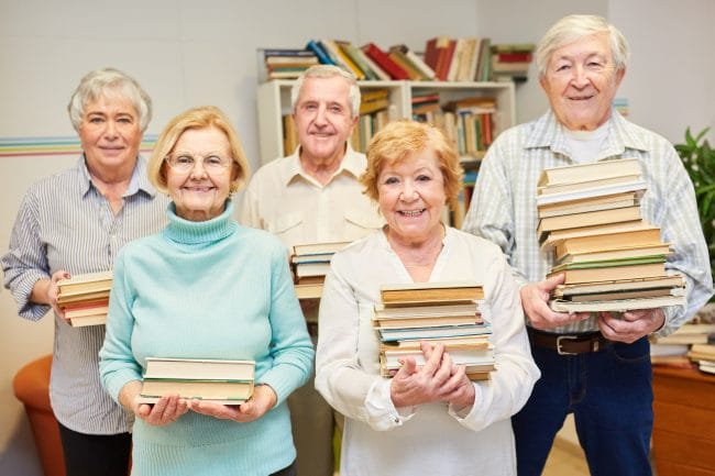 Group of seniors with a lot of books - Budget and the Bees